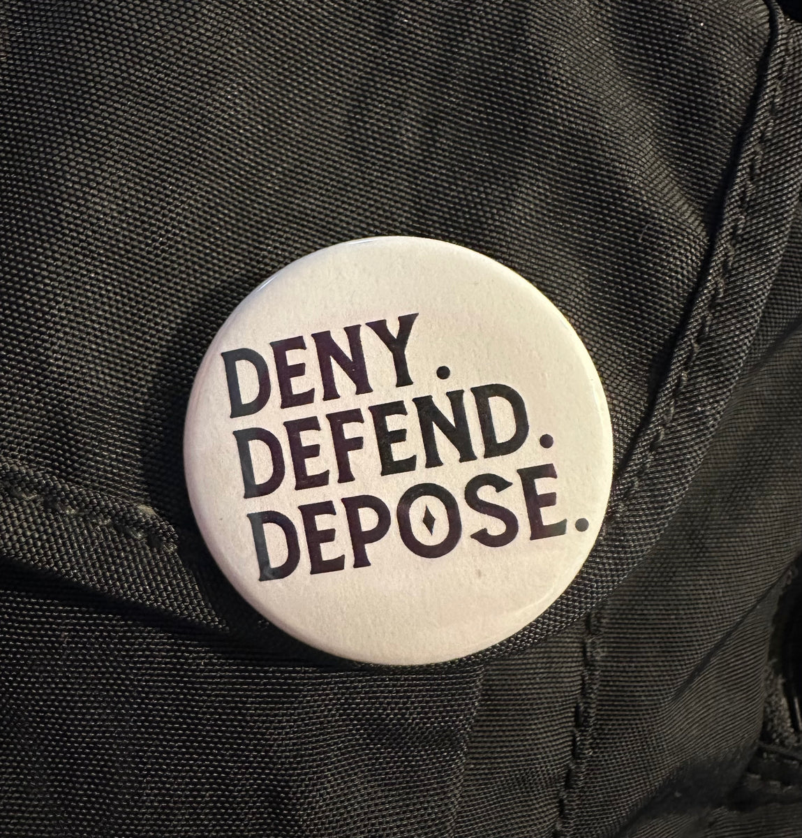 Deny. Defend. Depose. Button – Hilarious Humanitarian
